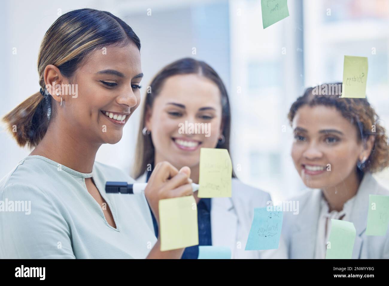 Business, team and woman writing on sticky note, success and planning ...