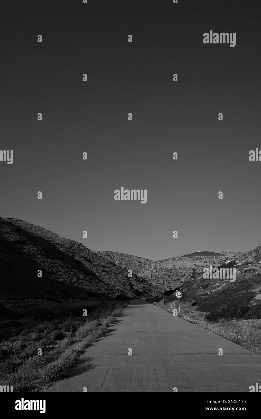 View of an empty road on the island of Ios Greece and a speed limit ...