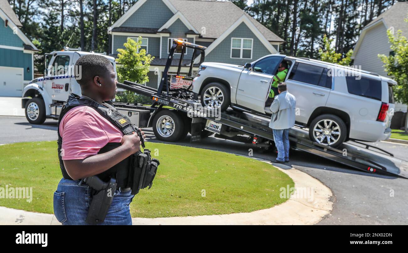 Cobb County sheriff deputies secure a vehicle for towing after the Cobb ...
