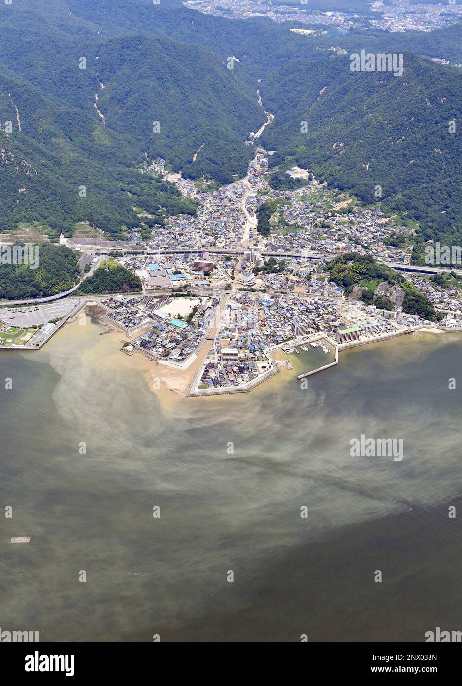 An aerial photo shows muddy water flowing out of river in Kure City ...