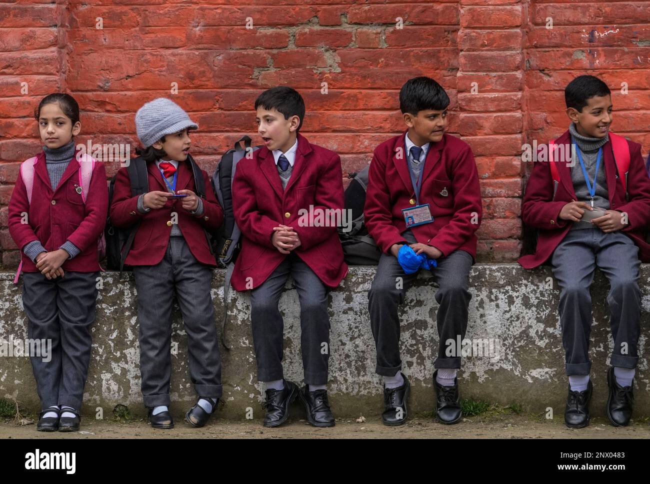 Kashmiri school children wait for the morning assembly after arriving ...