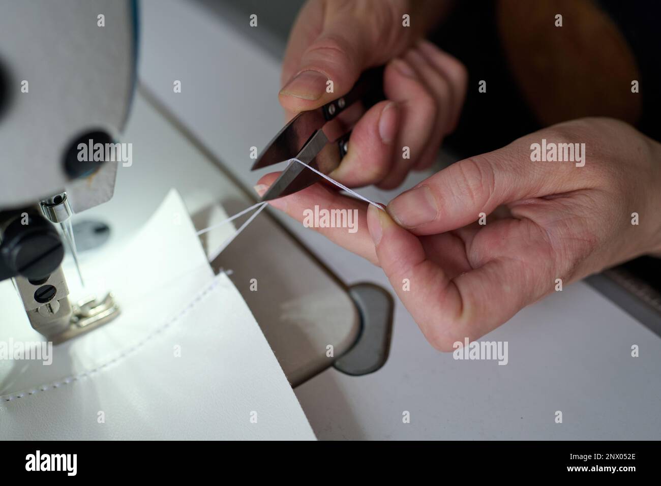 Cutting thread after sewing hi-res stock photography and images - Alamy