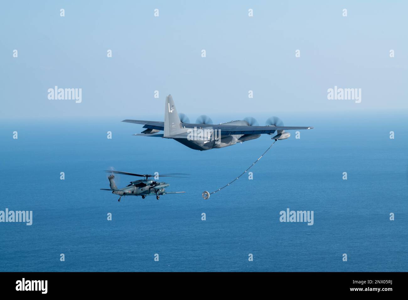 A U.S. Air Force MC-130 Commando II moves into position to provide air ...