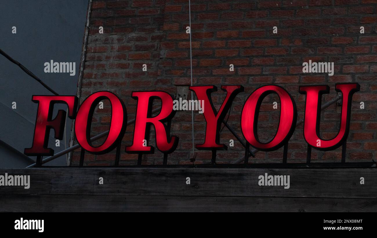 Red lettering for you sign against a brick wall loft style Stock Photo ...