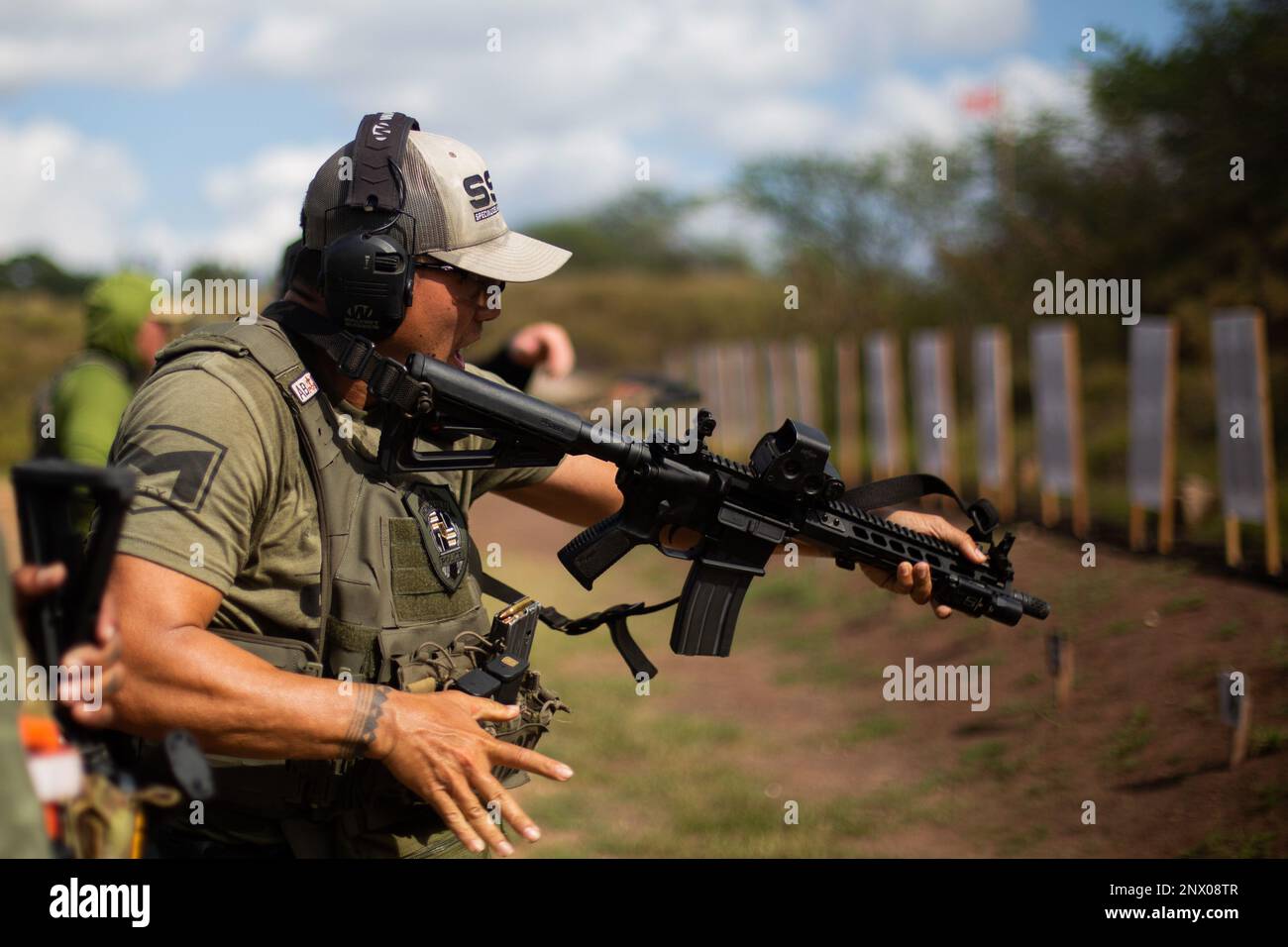 An officer with the Honolulu Police Department fires an M4 service ...