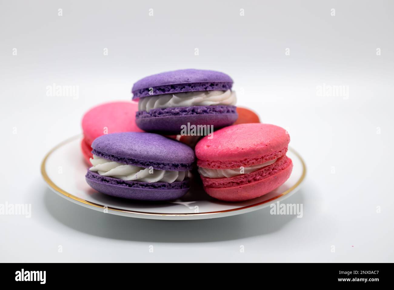 This image shows a close-up view of colorful French macaron confections ...