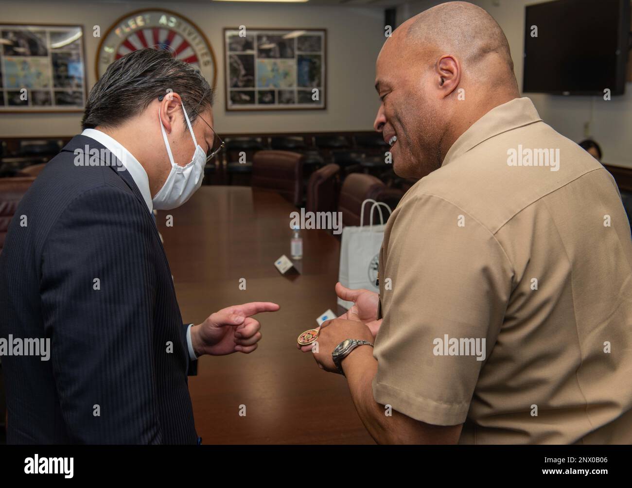 Capt. David Adams, Commander, Fleet Activities Sasebo (CFAS), presents ...