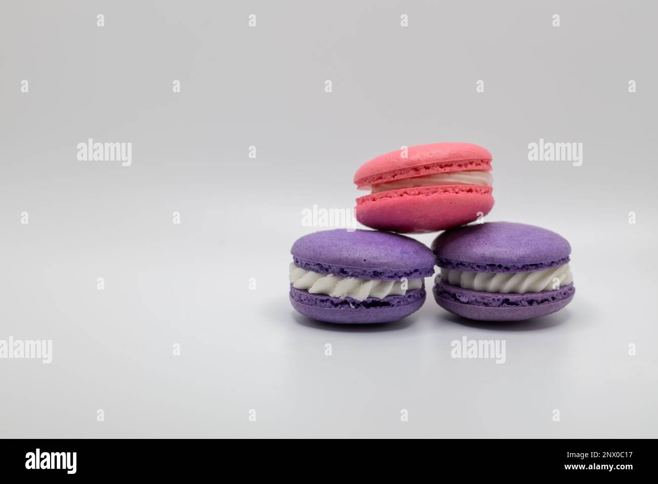 This image shows a close-up view of colorful French macaron confections ...