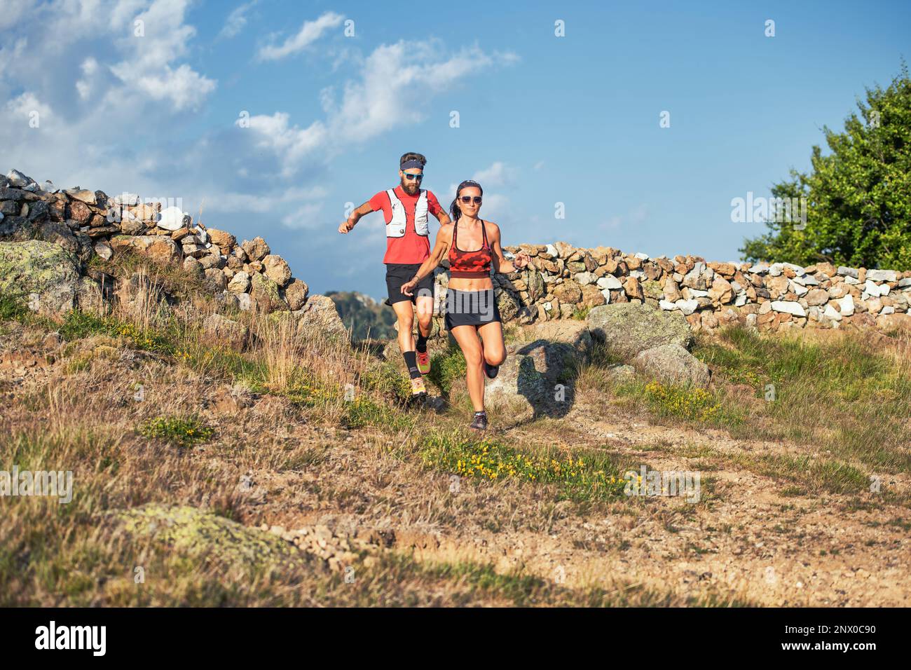 An athletic couple during a nature run in the hills Stock Photo - Alamy