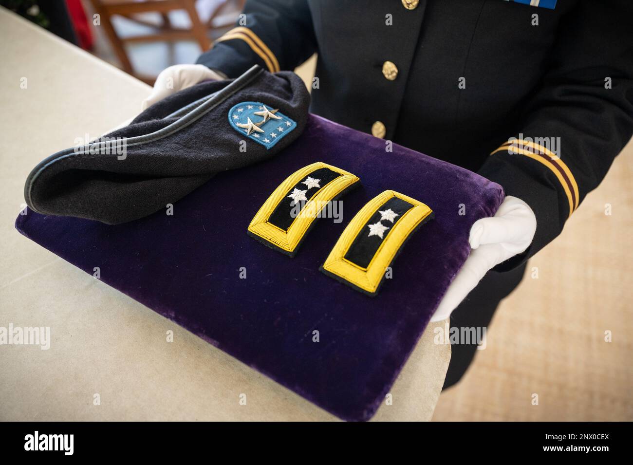 Two-star shoulder boards are presented by a proffer Maj. Gen. Roy ...