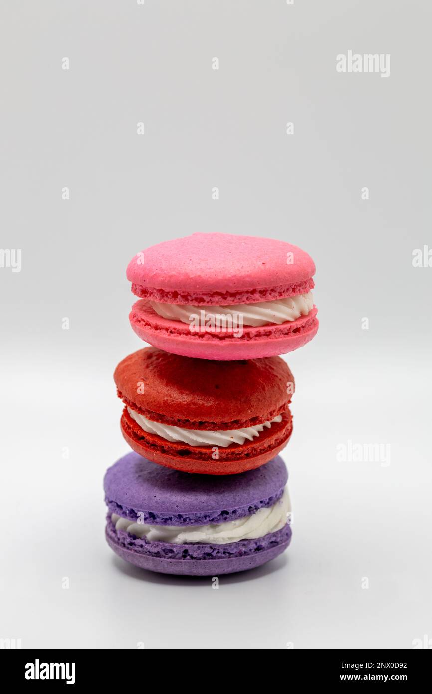 This image shows a close-up view of colorful French macaron confections ...