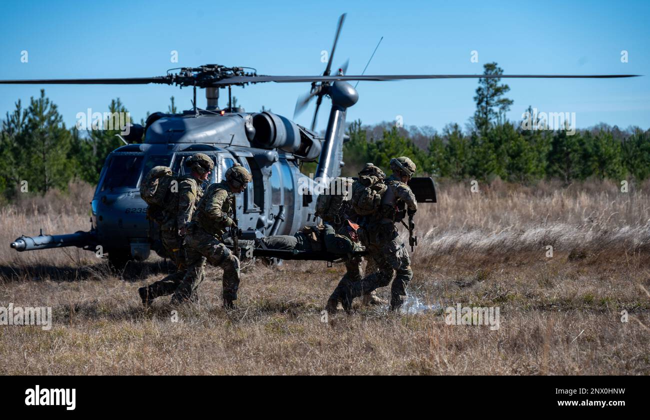 920th Rescue Wing Pararescuemen transport a simulated patient to an HH ...