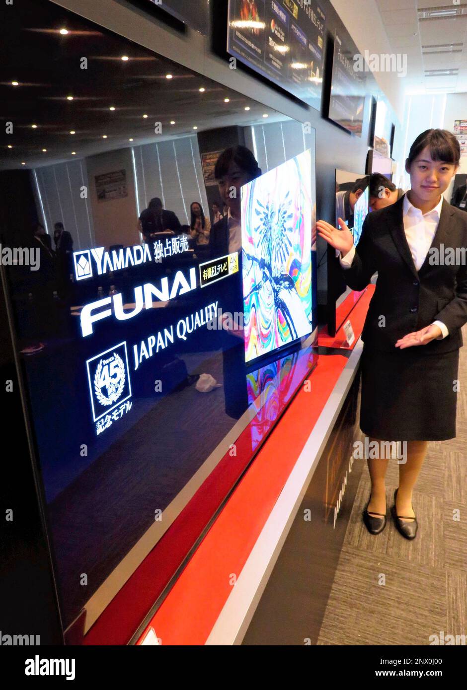 A woman introduces a 65-inch TV using organic EL (electro-luminescence ...