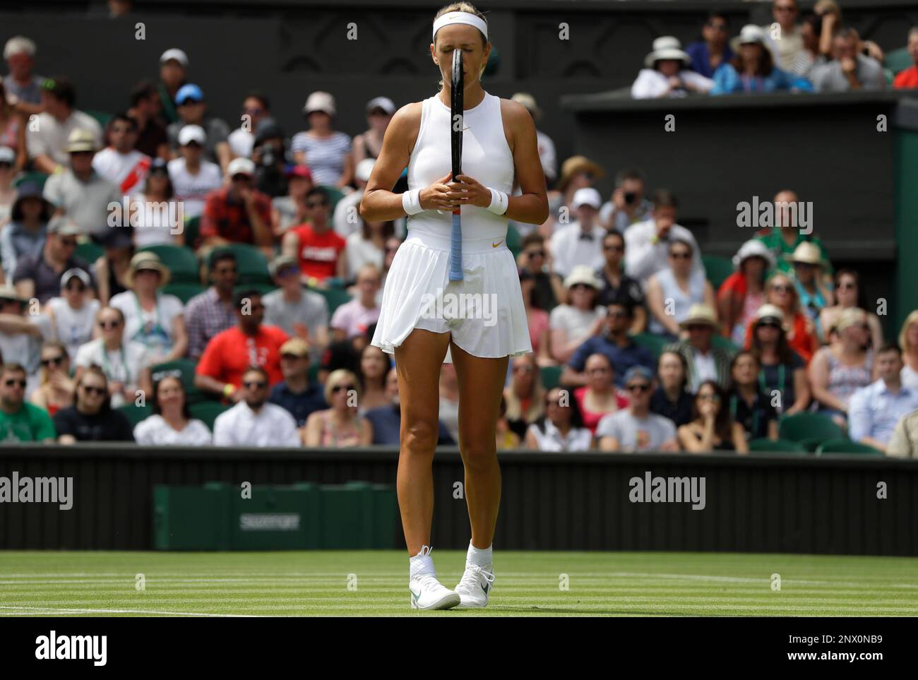 Victoria Azarenka, of Belarus, chews on her racket after loosing a ...