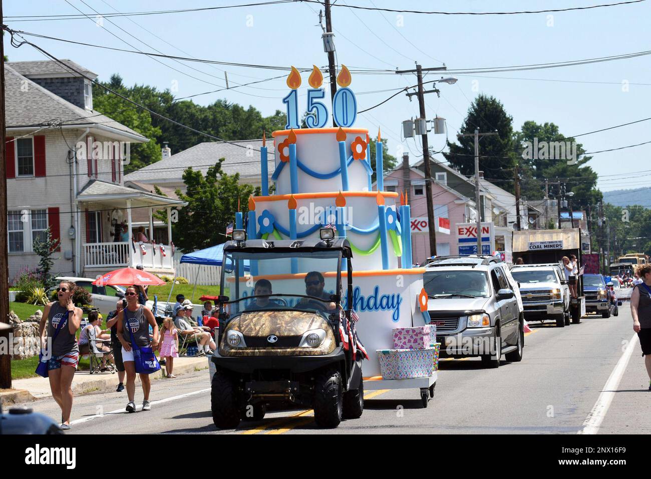 Steve Barner and passenger Aidan Barner drive the 150th birthday cake ...
