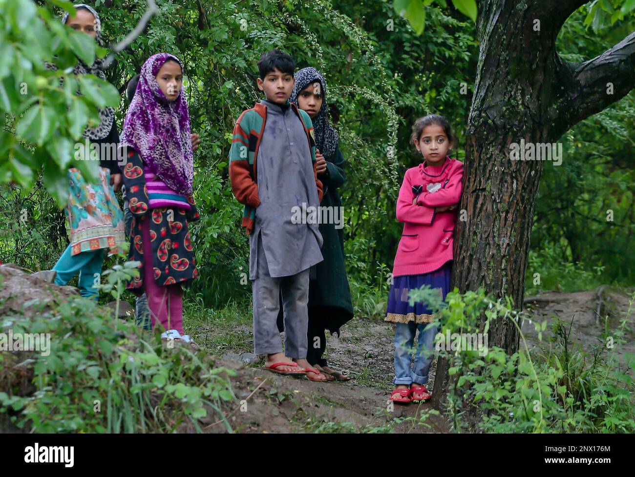 Kashmiri children watch the funeral procession of a teenage boy Faizan ...