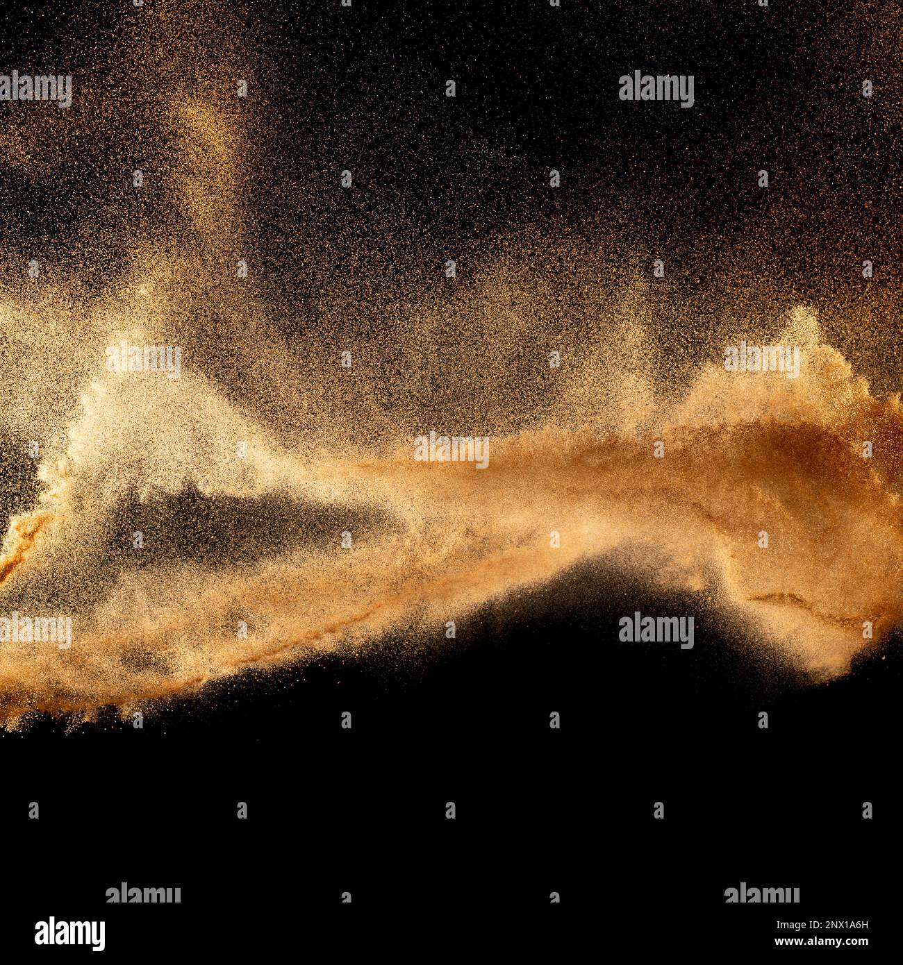 Sand explosion isolated on black background. Freeze motion of sandy ...