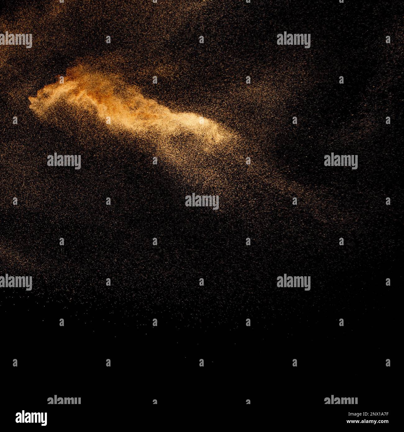 Sand explosion isolated on black background. Freeze motion of sandy ...