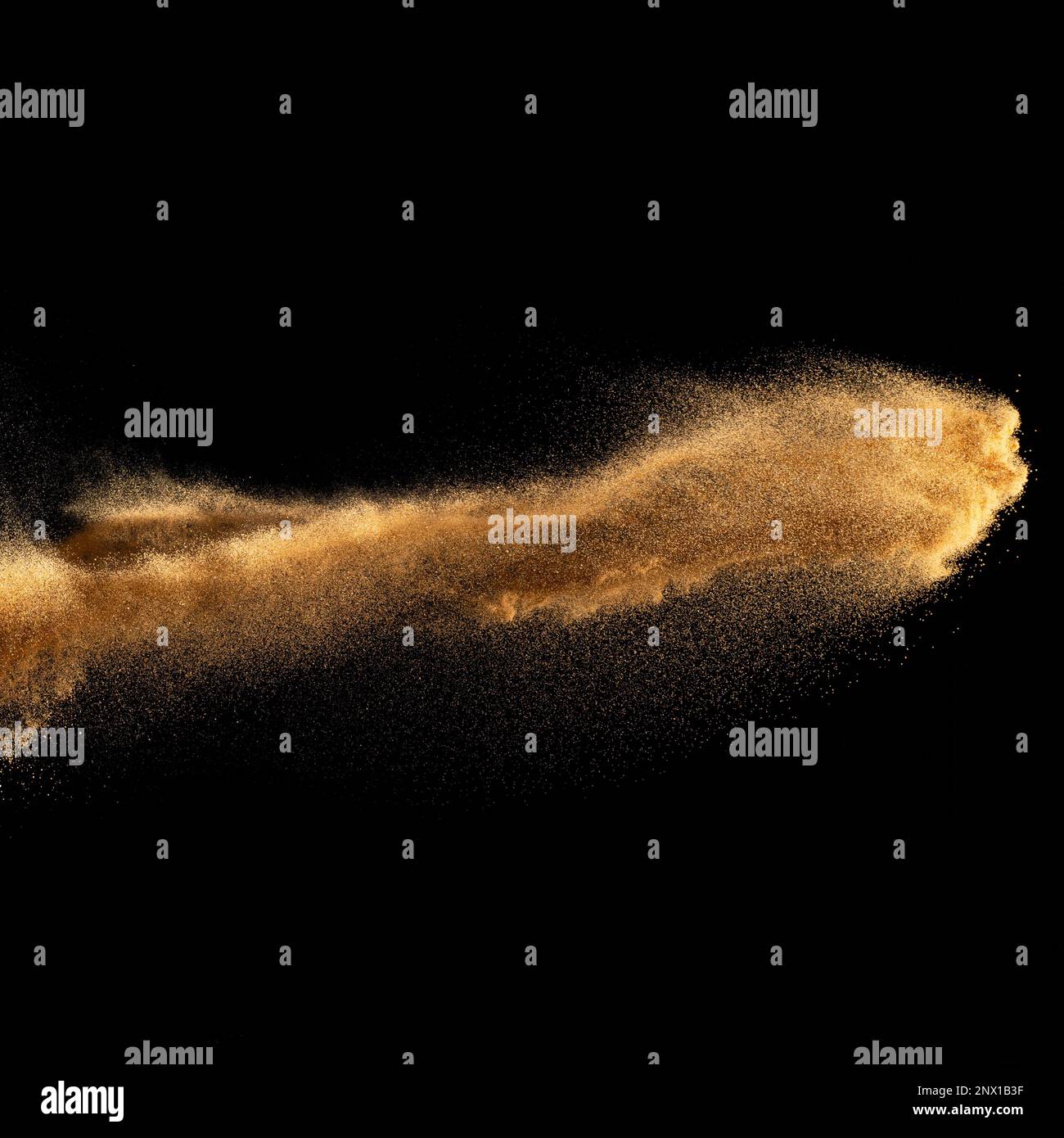 Sand explosion isolated on black background. Freeze motion of sandy ...