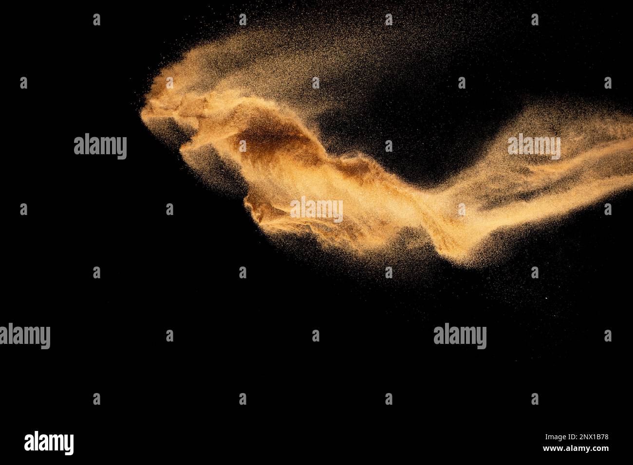 Sand explosion isolated on black background. Freeze motion of sandy ...