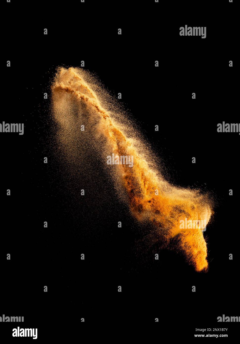 Sand explosion isolated on black background. Freeze motion of sandy ...