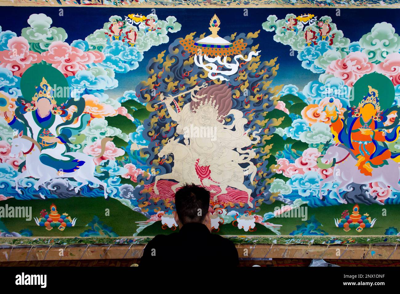 Exile Tibetan artist Tenzin Yeshi, 29, paints a traditional painting ...