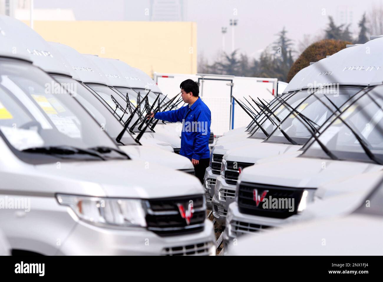 QINGDAO, CHINA - FEBRUARY 1, 2023 - An employee looks at new cars on display at the Shandong ...