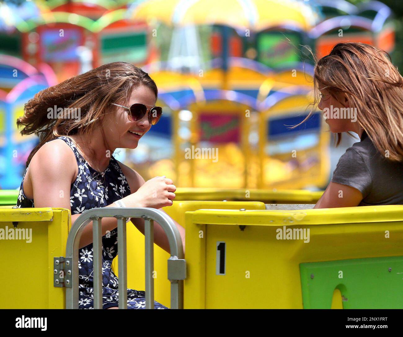 Kayla Baez, 14, left, and Isabel Wilson, 13, spin in the Tubs of Fun ...