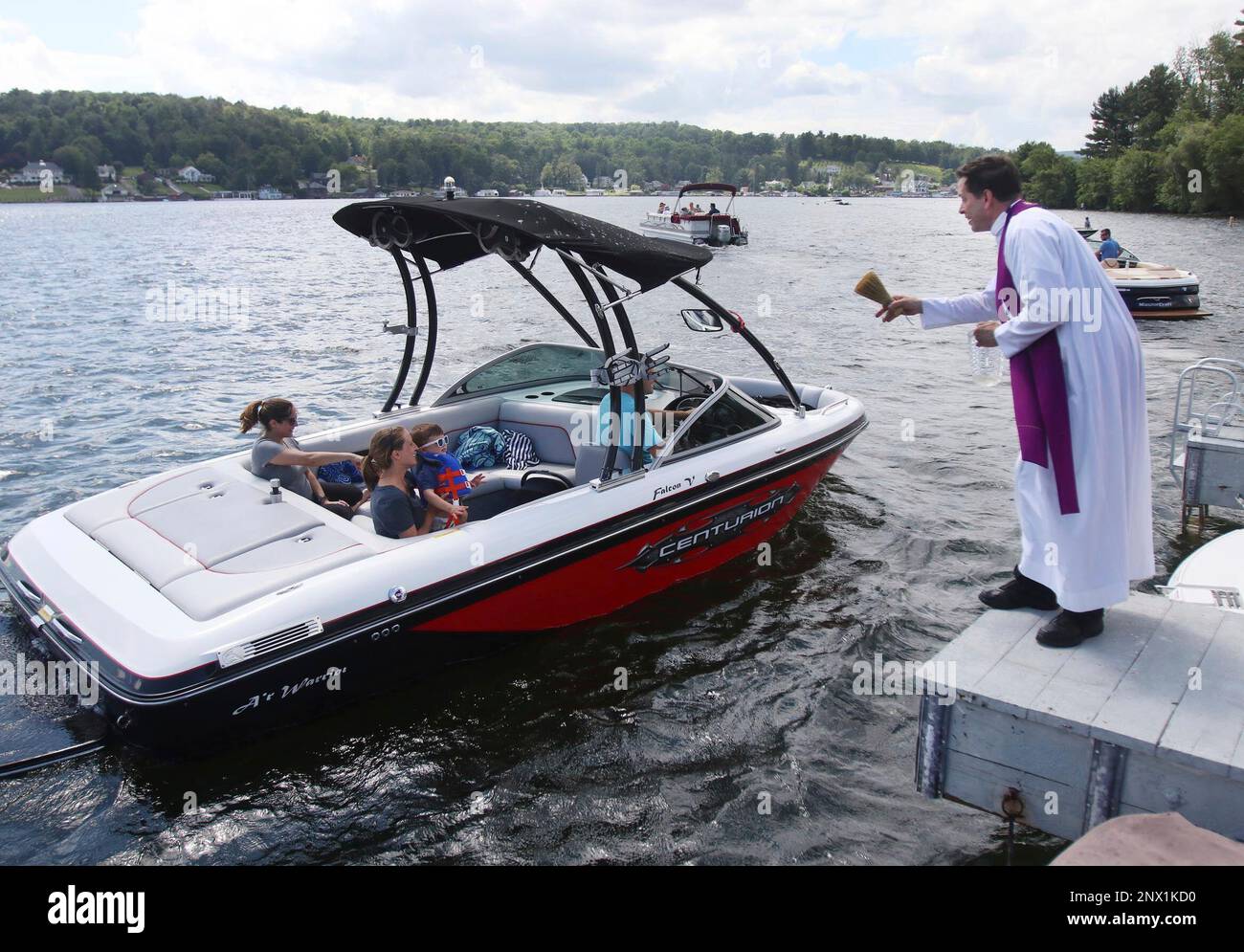 Father Daniel Toomey, of Our Lady of Victory Church, blesses one of ...