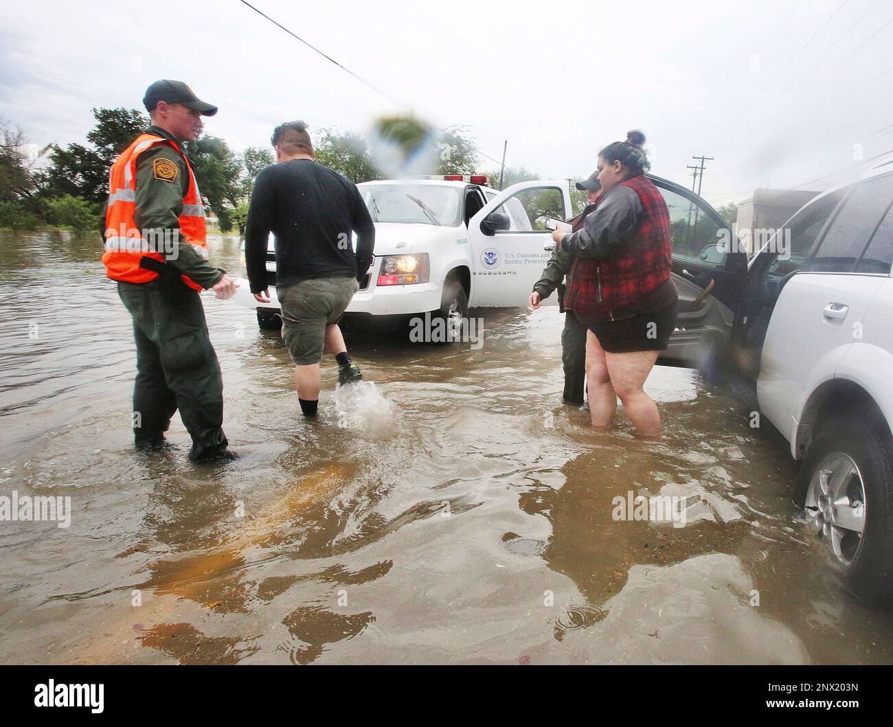 U.S. Border Patrol agents help a stranded motorist on Bryan Road after ...
