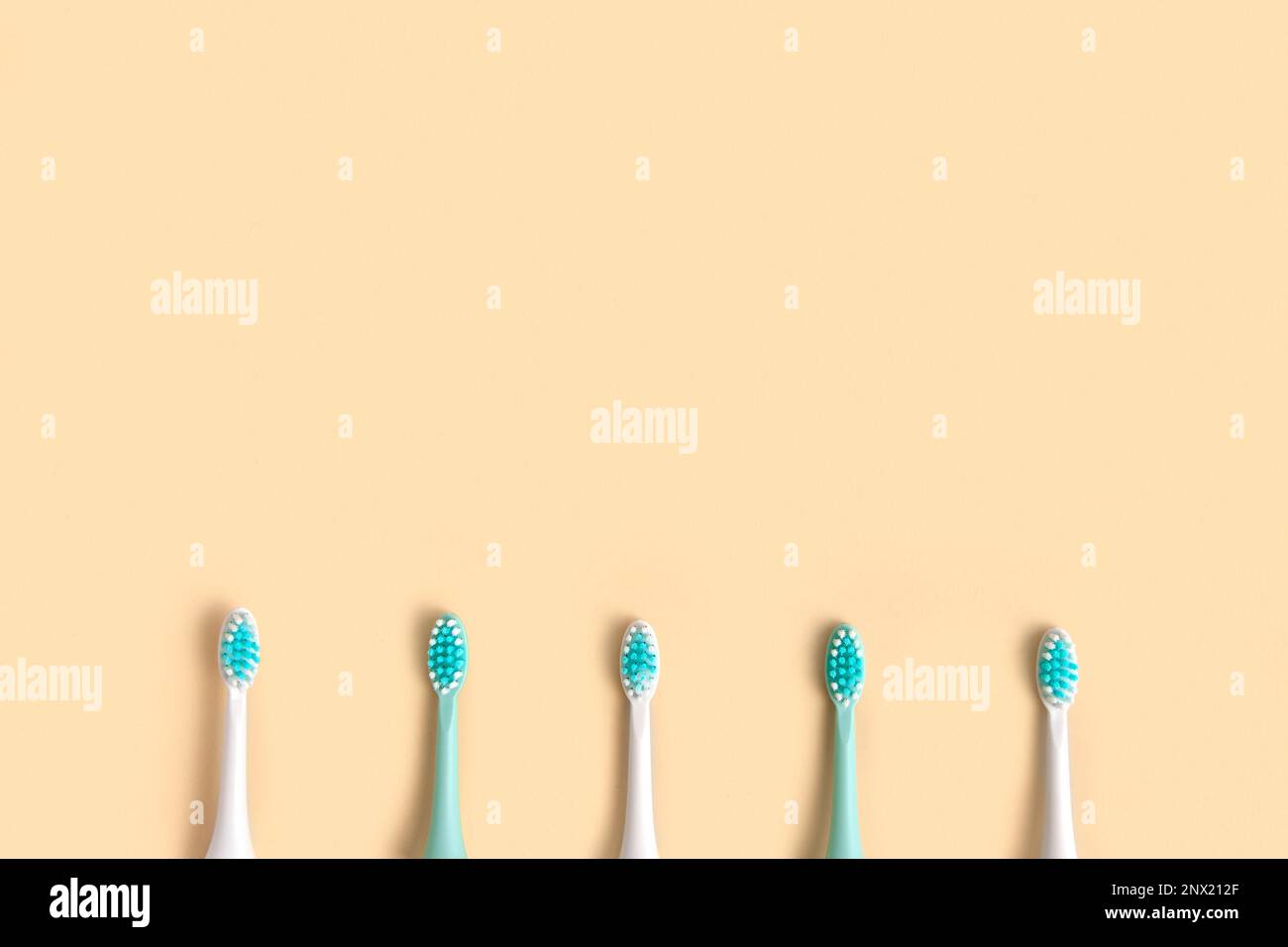 Toothbrushes on a beige neutral pastel color studio background. Top ...