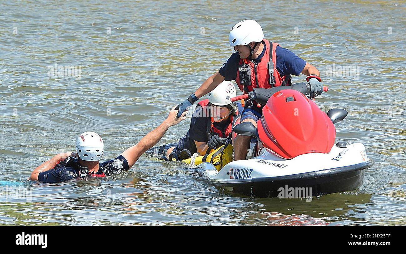 Yuma Fire Department firefighter Mauro Rodriguez, right, grabs the hand ...