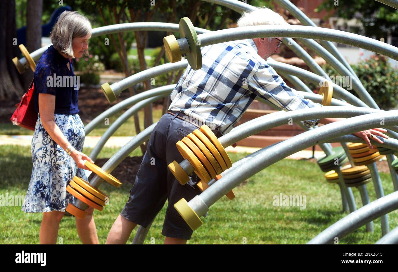 Jim and Eva Hoke of Chapel Hill interact with the Abacus Wave sculpture ...