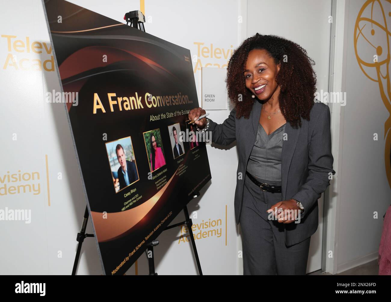 Chairman, Universal Studio Group Pearlena Igbokwe signs a poster before ...