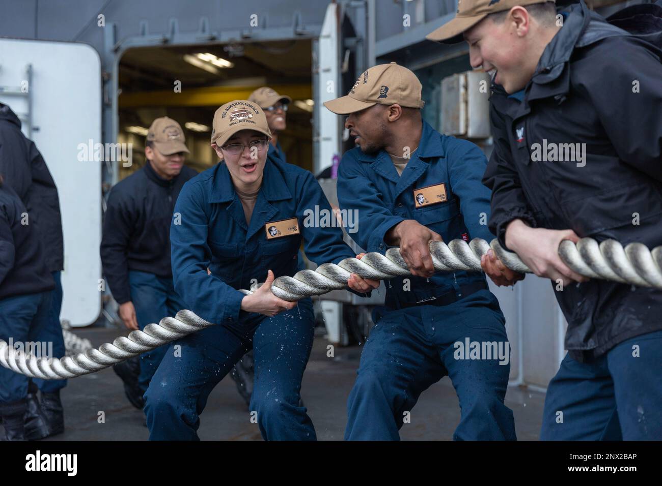 Sailors heave around lines on the fantail aboard the Nimitz-class ...
