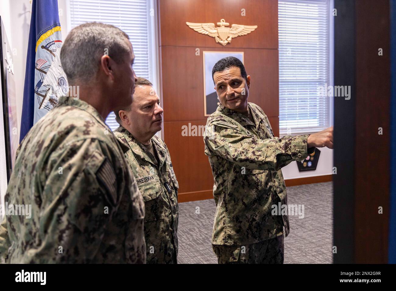Chief of Naval Personnel Vice Adm. Rick Cheeseman, center, is given a ...