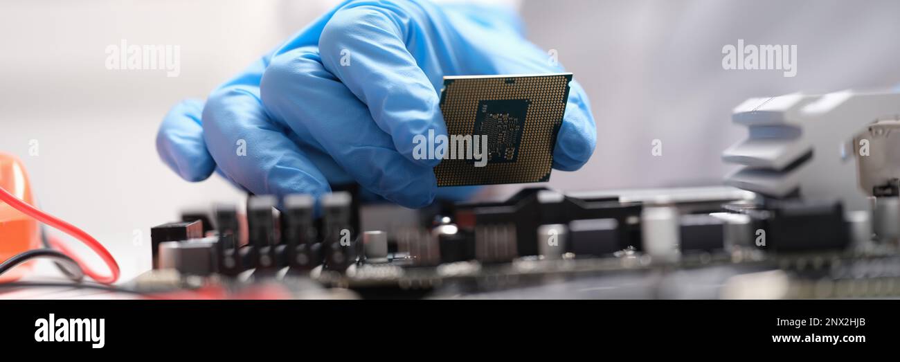 Technician connects a CPU microprocessor to motherboard socket Stock Photo - Alamy