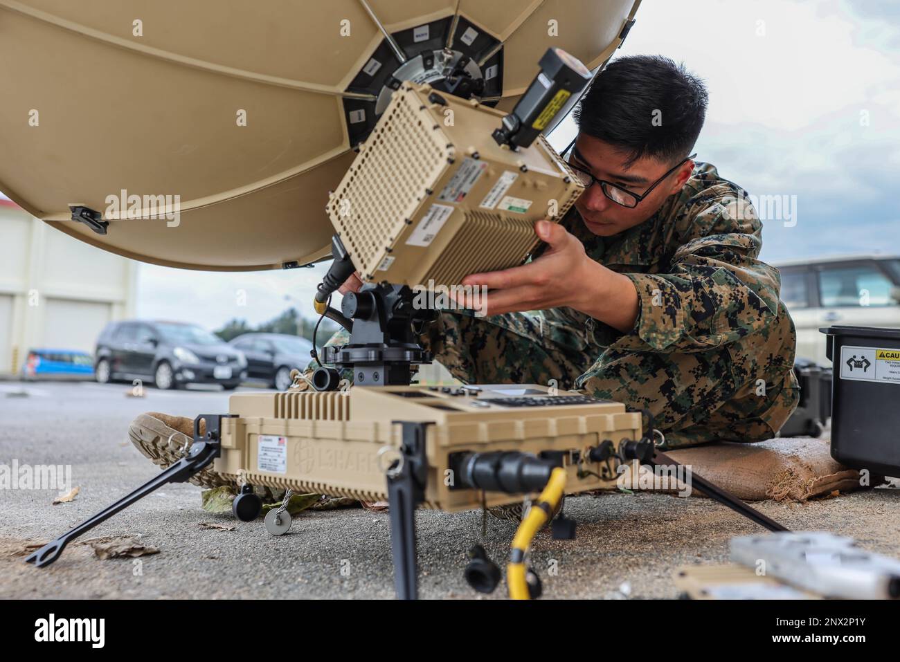 U.S. Marine Corps Pfc. Henry Li, a satellite transmission system ...