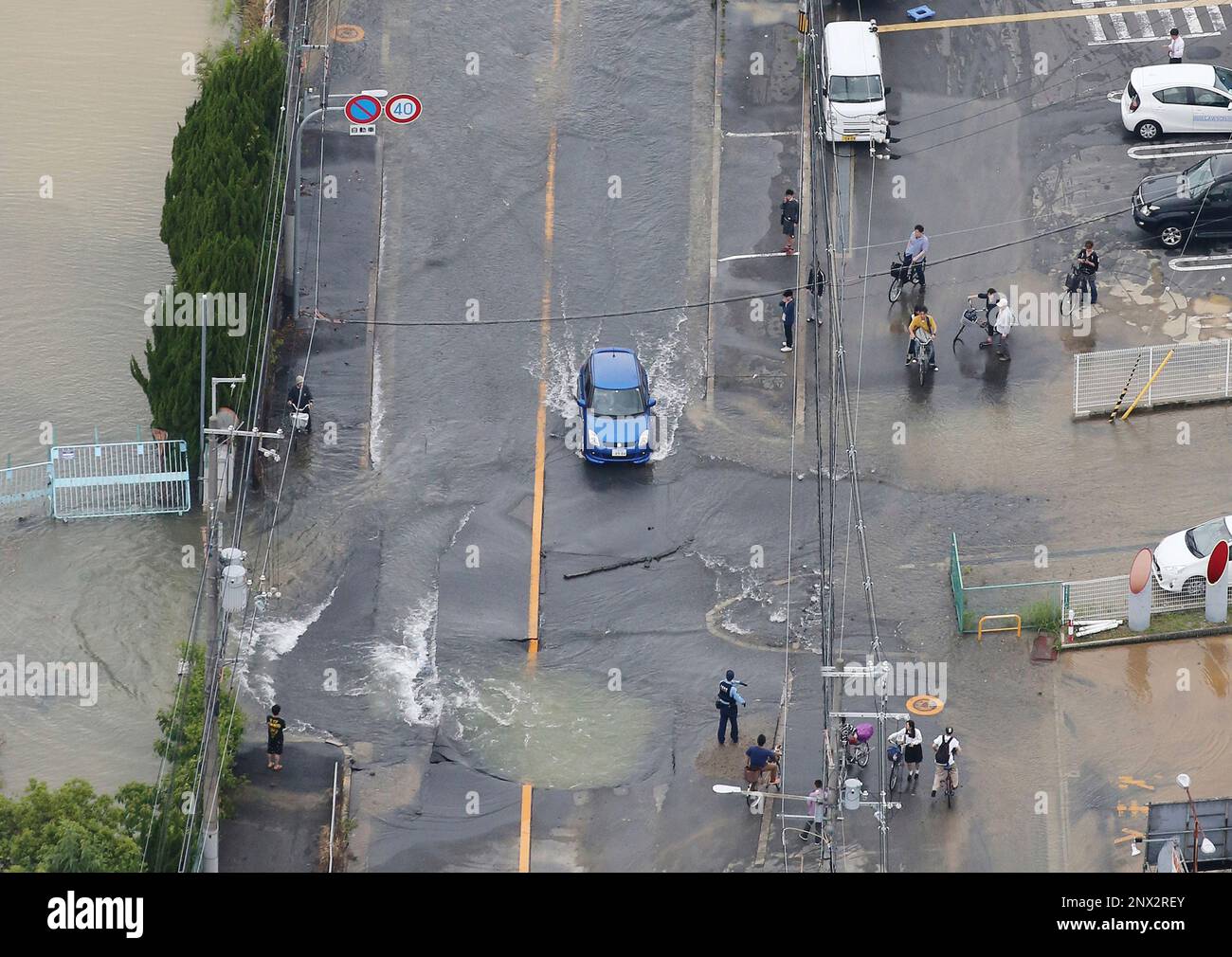 An aerial photo shows a road that is collapsed and flooded by water due ...
