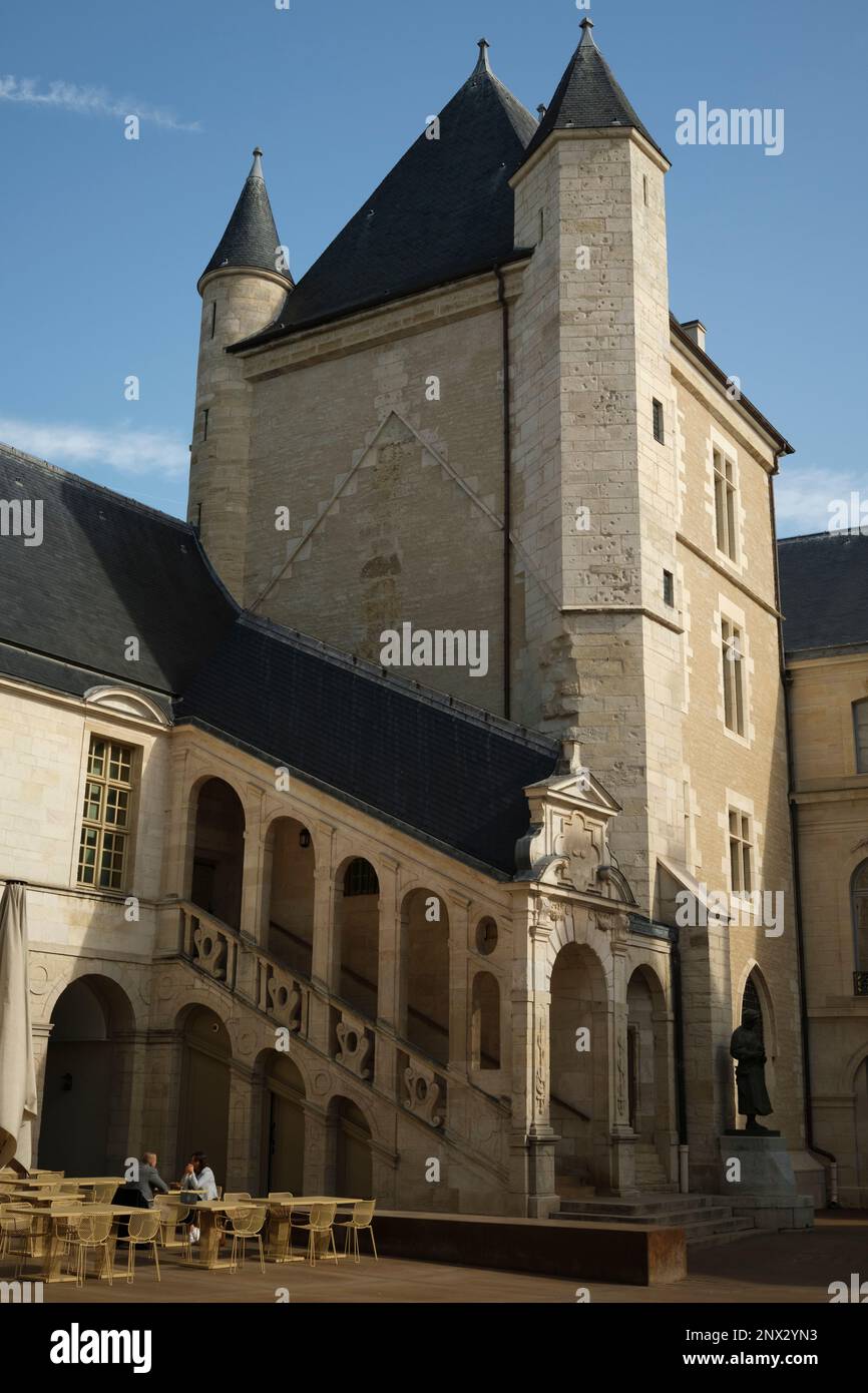 Inner courtyard with street cafe near tower of an ancient building in ...