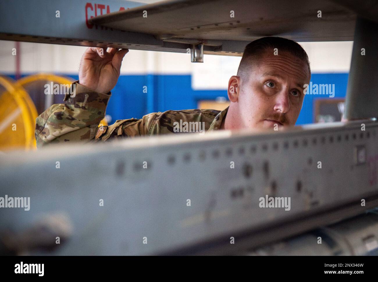 A 96th Maintenance Group evaluator judges the F-16 weapons load. Two ...