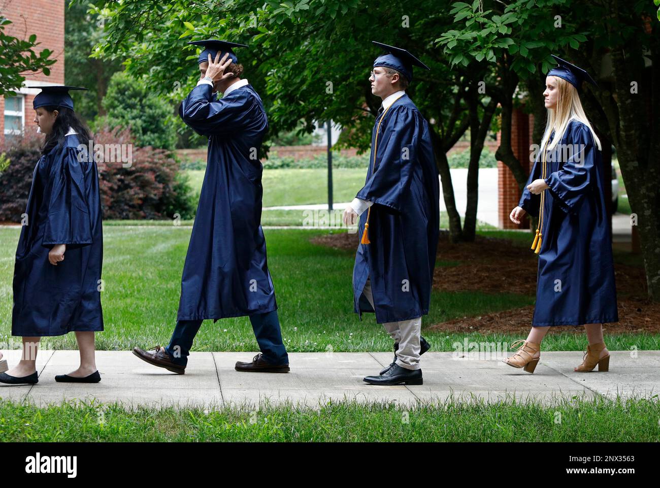Graduating seniors walk in a processional into the graduation ceremony ...