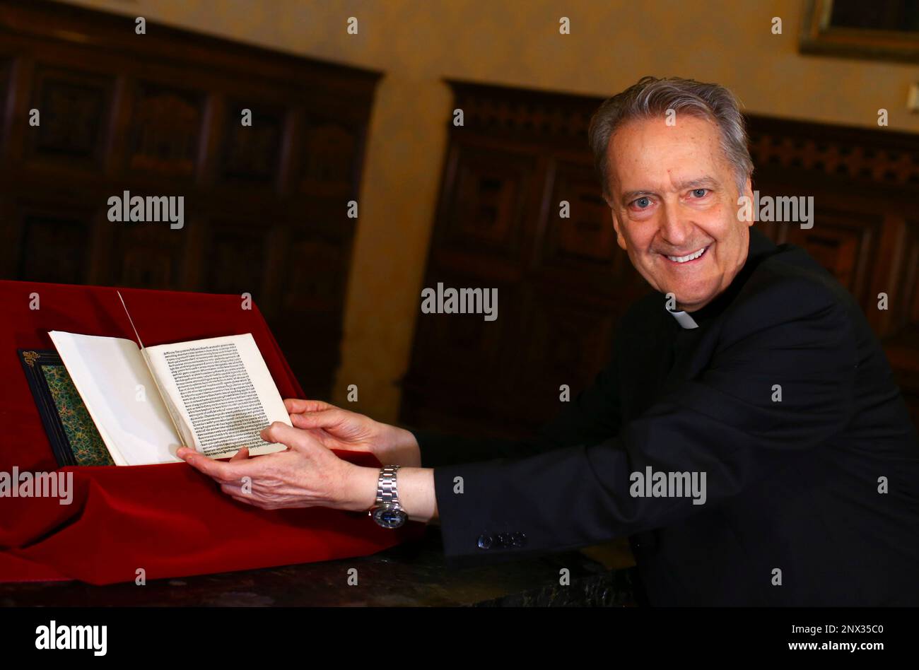 Prefect of the Vatican Library Bishop Cesare Pasini leafs through an ...