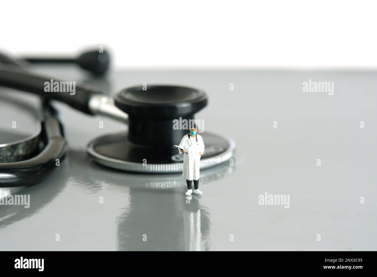 Miniature people toy figure photography. Health concept. A women doctor ...