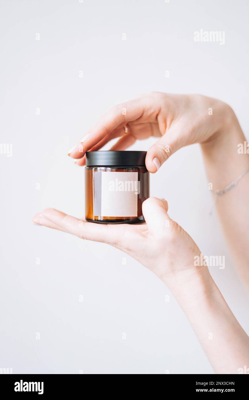 Hand holding blank food jar hi-res stock photography and images - Alamy