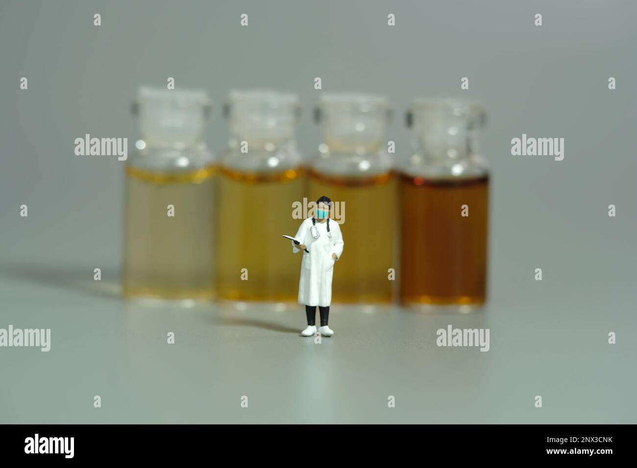 Miniature people toy figure photography. Urine test concept. A female ...