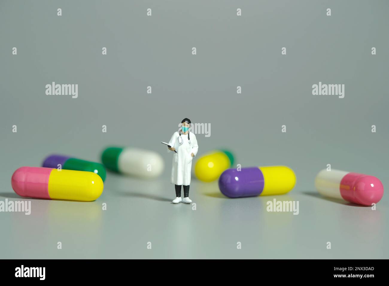 Miniature people toy figure photography. A female doctor standing in ...