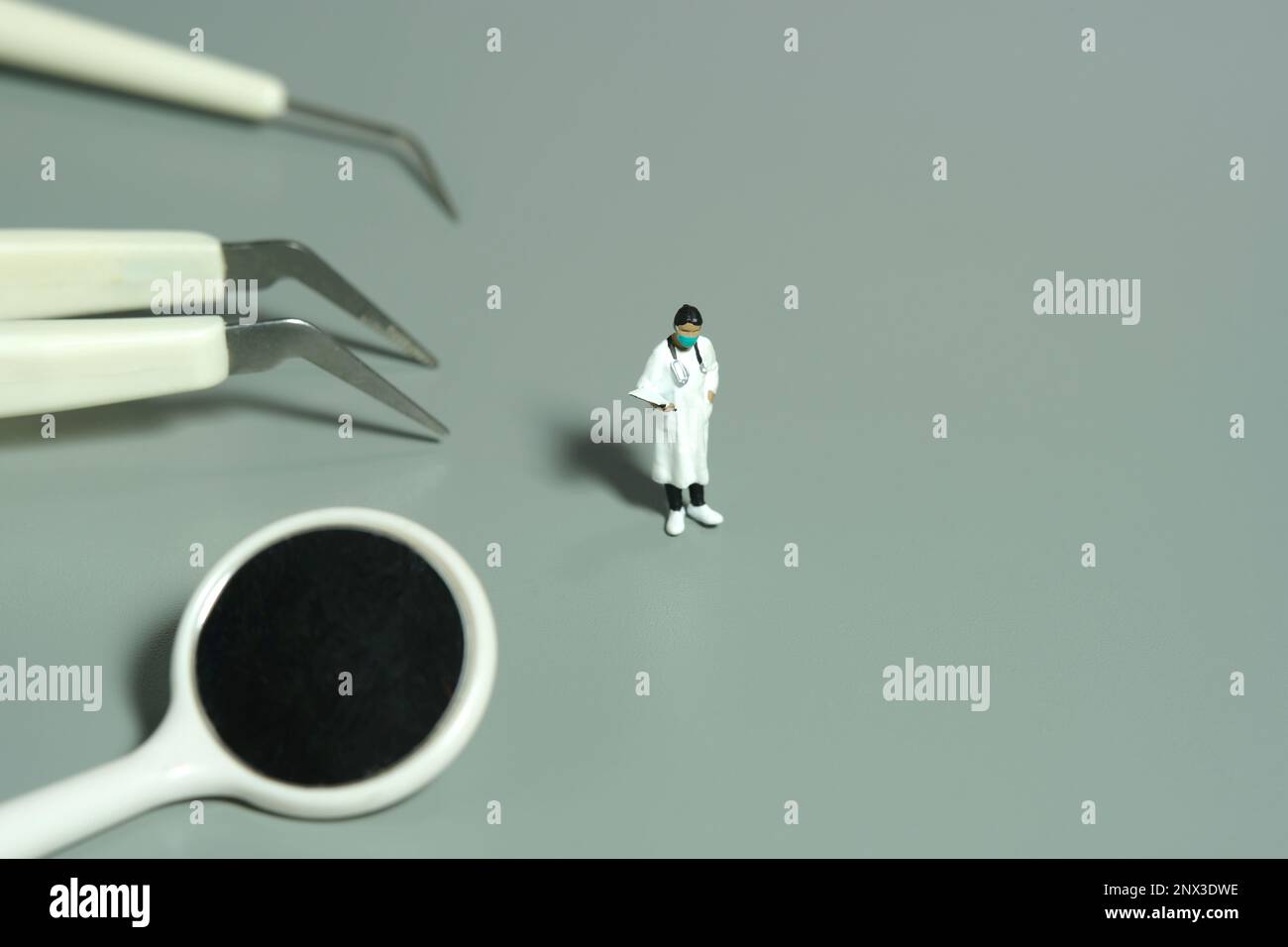 Miniature people toy figure photography. A female doctor holding ...