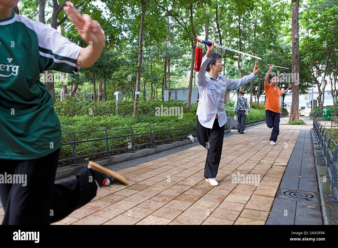 people practicing tai chi with swords in the early morning in Victoria ...