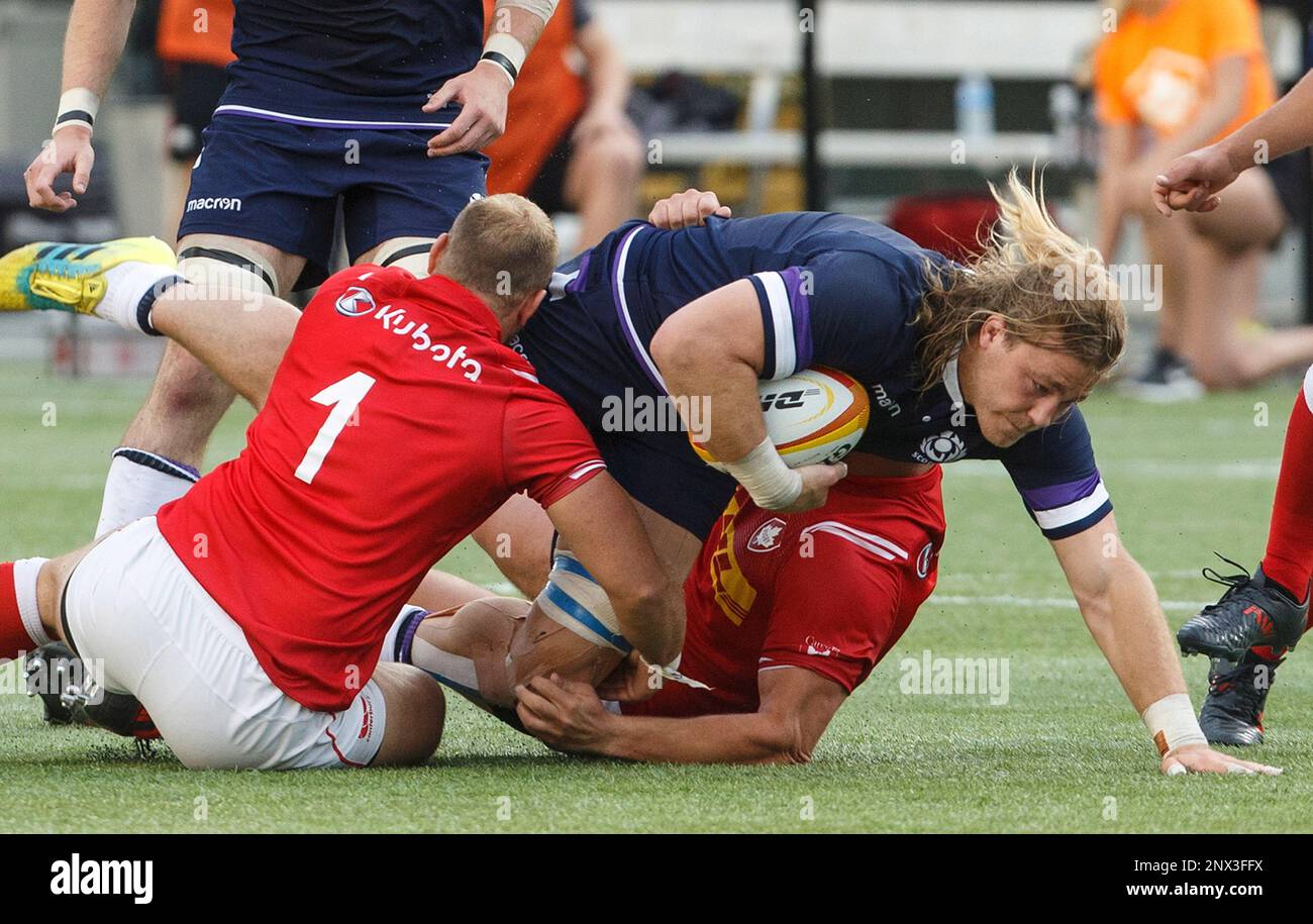 Scotland's David Denton, front right, is tackled by Canada's Noah Barker (1) during the first ...